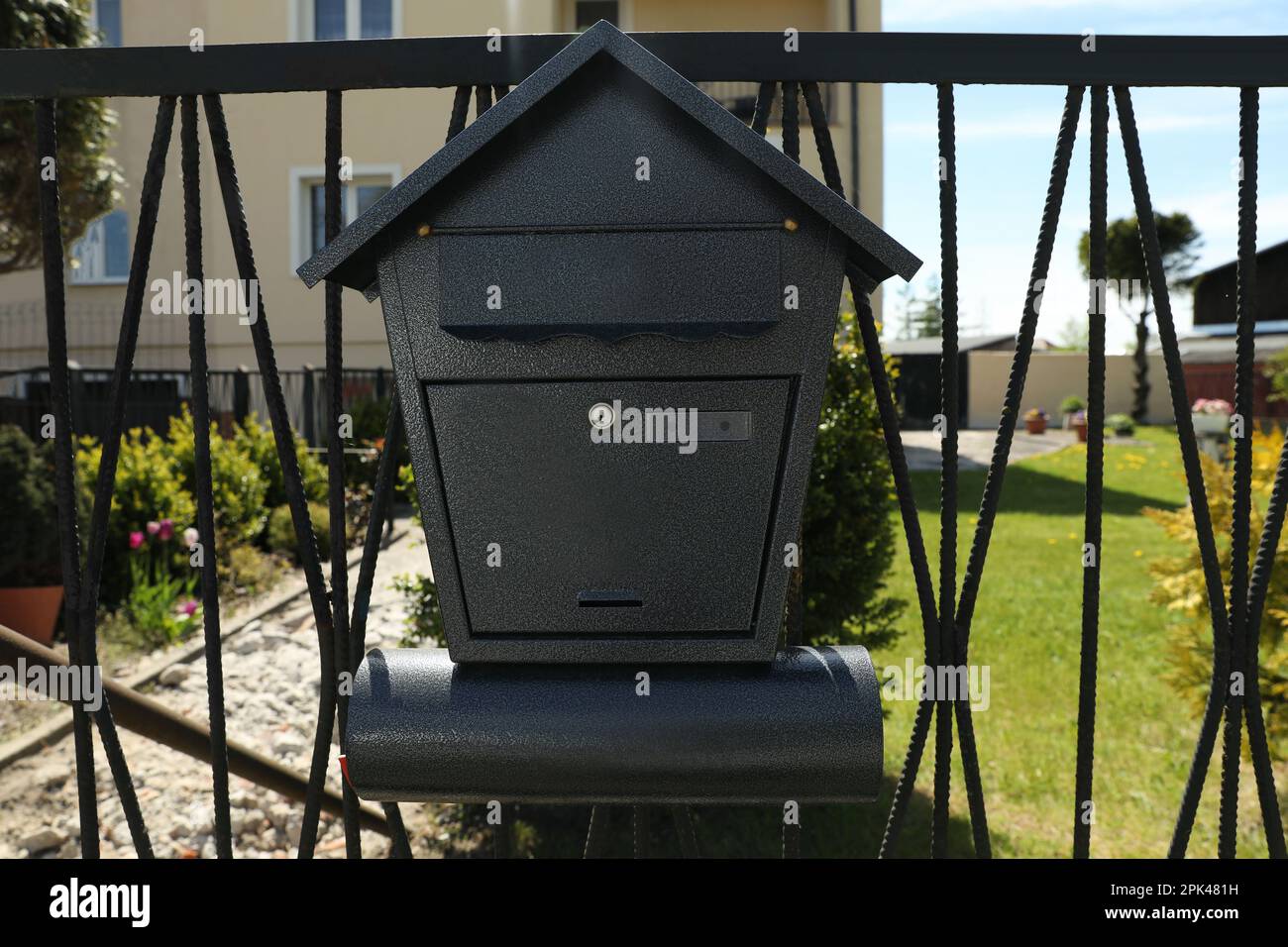 Black metal letter box on fence outdoors Stock Photo - Alamy