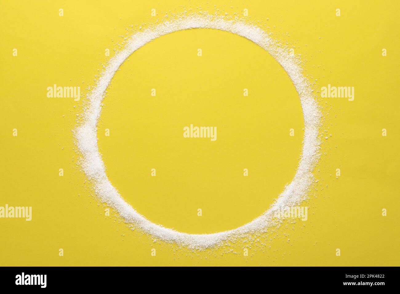 Frame made of granulated sugar on yellow background, top view. Space ...