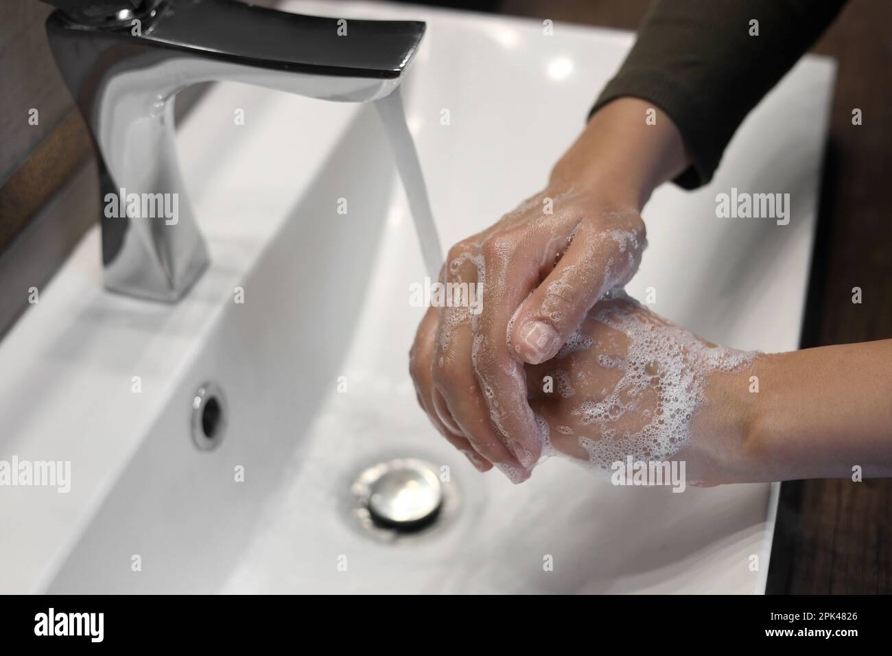 Washing hands in sink hi-res stock photography and images - Alamy