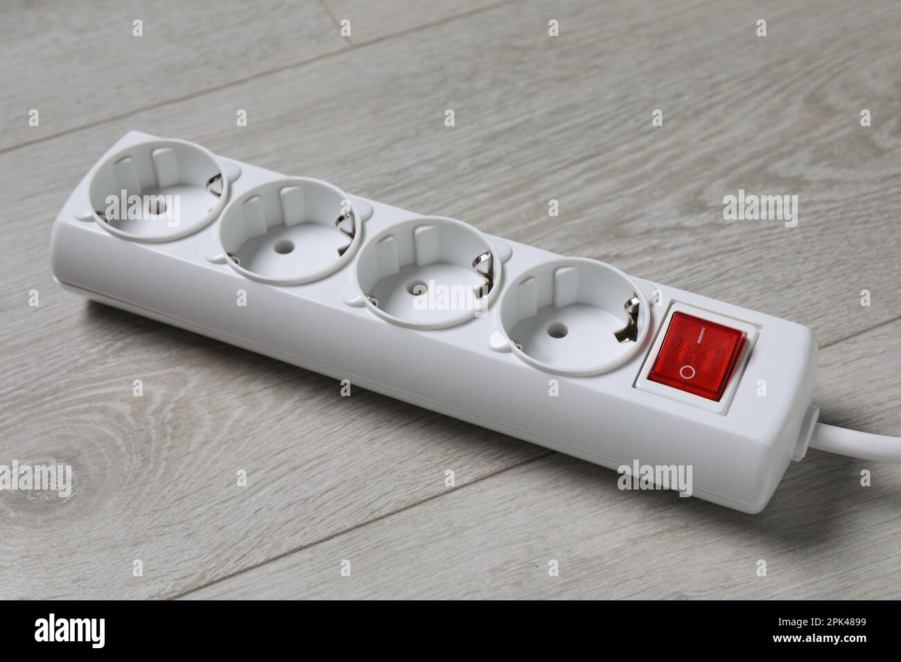 Power strip on wooden floor, closeup. Electrician's equipment Stock ...