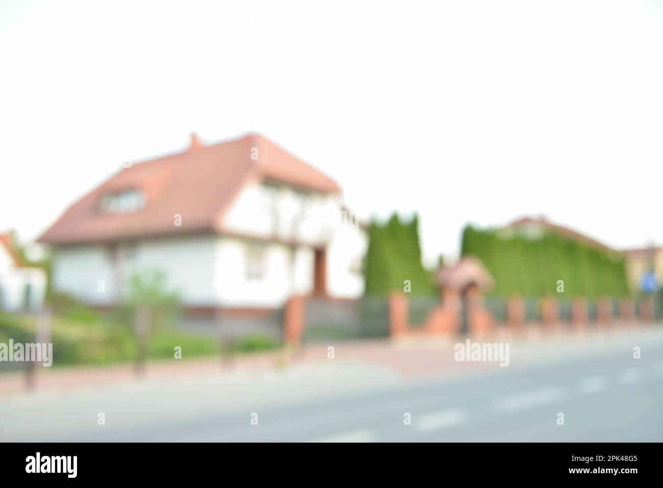 Blurred view of suburban street with beautiful house Stock Photo - Alamy
