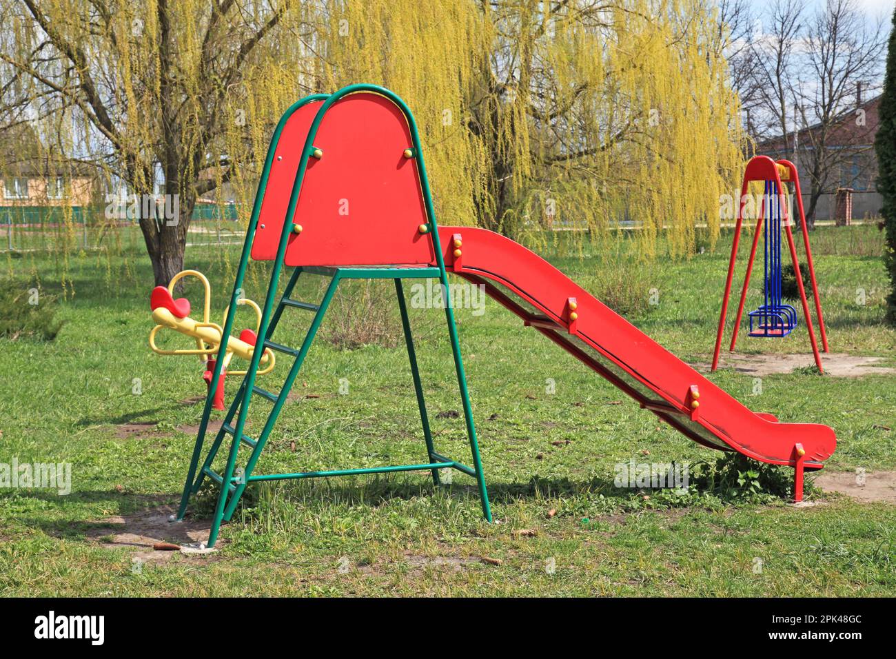 Children's playground in the park. New and modern children's slide ...