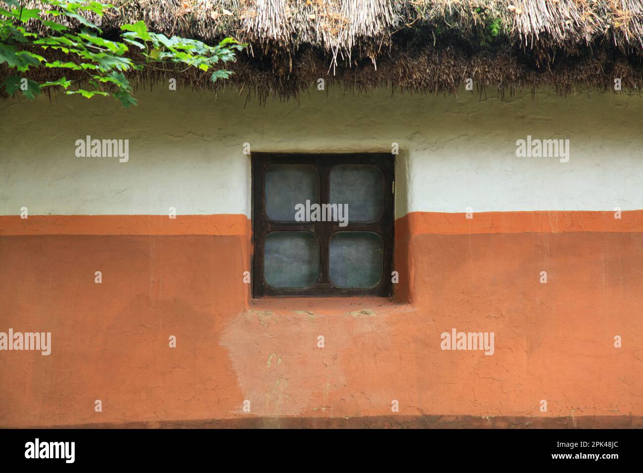 Window of an old wooden house (building) with a thatched roof of Kiev ...