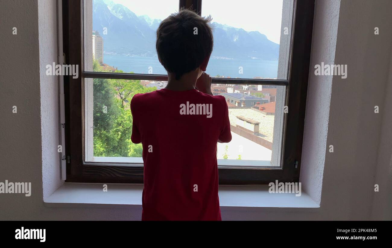 Child closing window. Young boy closes home window Stock Photo - Alamy