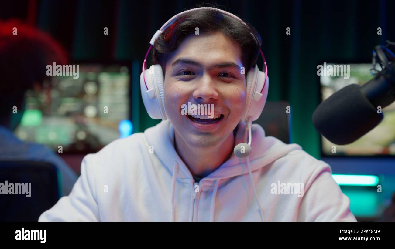 Game streamer using pc setup playing multiplayer first person shooter ...