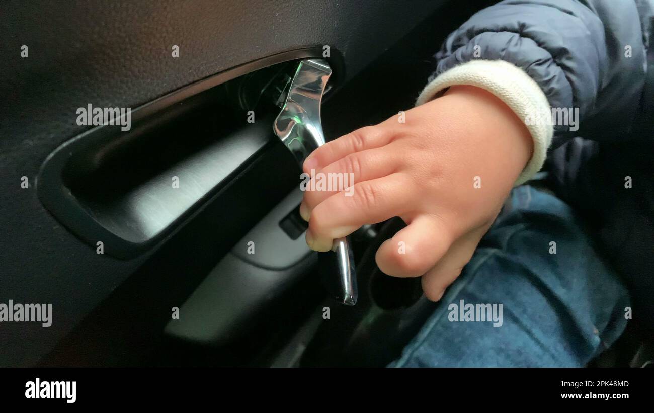 Child unable to open car handle because of lock safety prevention Stock ...