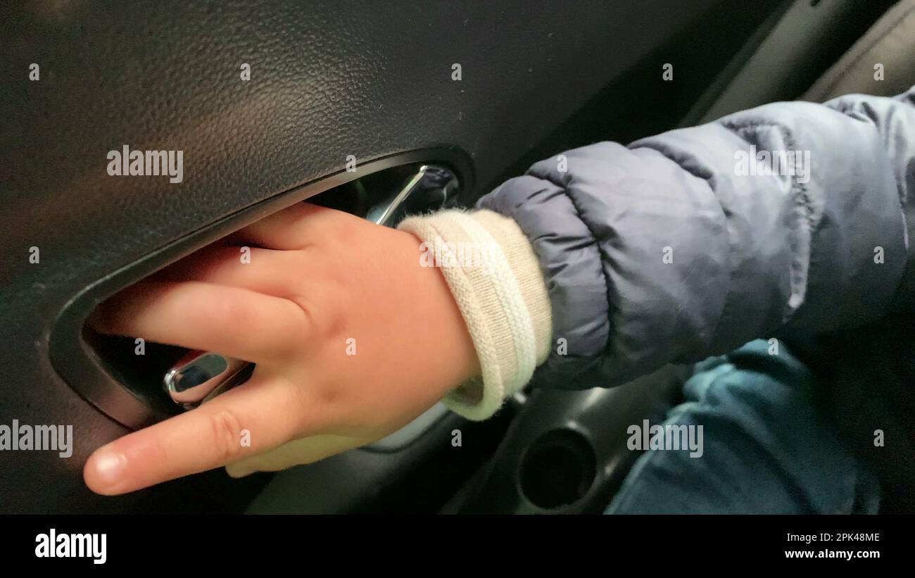 Child unable to open car handle because of lock safety prevention Stock ...