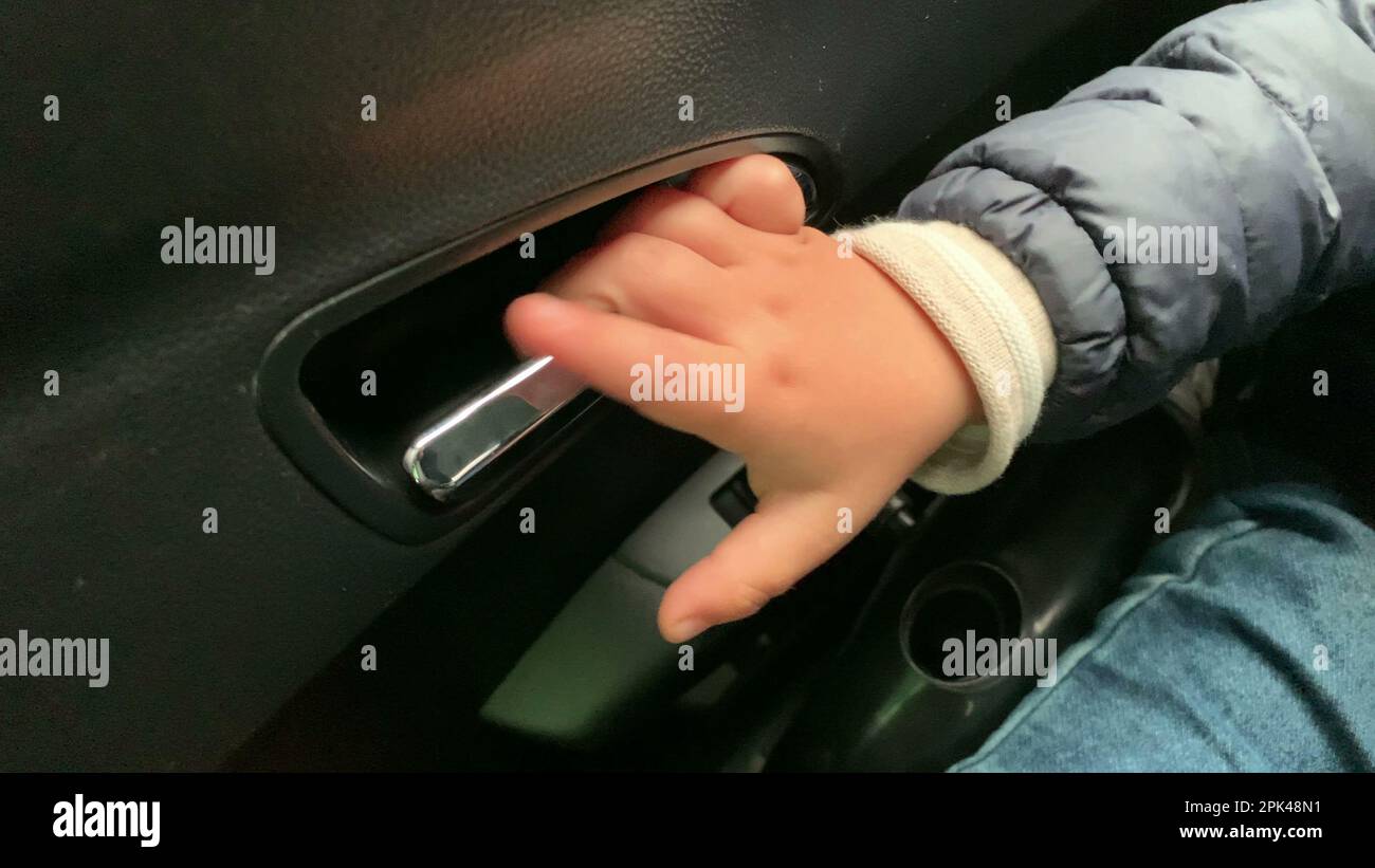 Child unable to open car handle because of lock safety prevention Stock ... Child unable to open car handle because of lock safety prevention Stock ...
