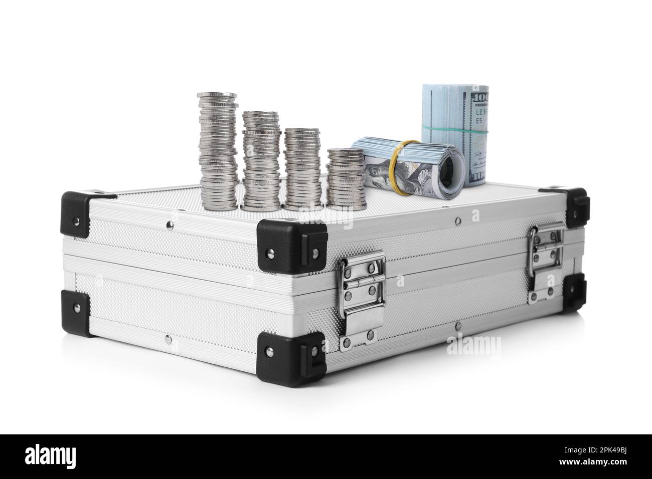 Aluminum hard case, rolled dollar banknotes and stack of coins on white ...