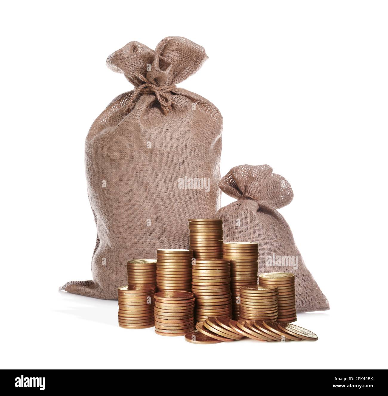 Stacked coins and sack full of money on white background Stock Photo ...