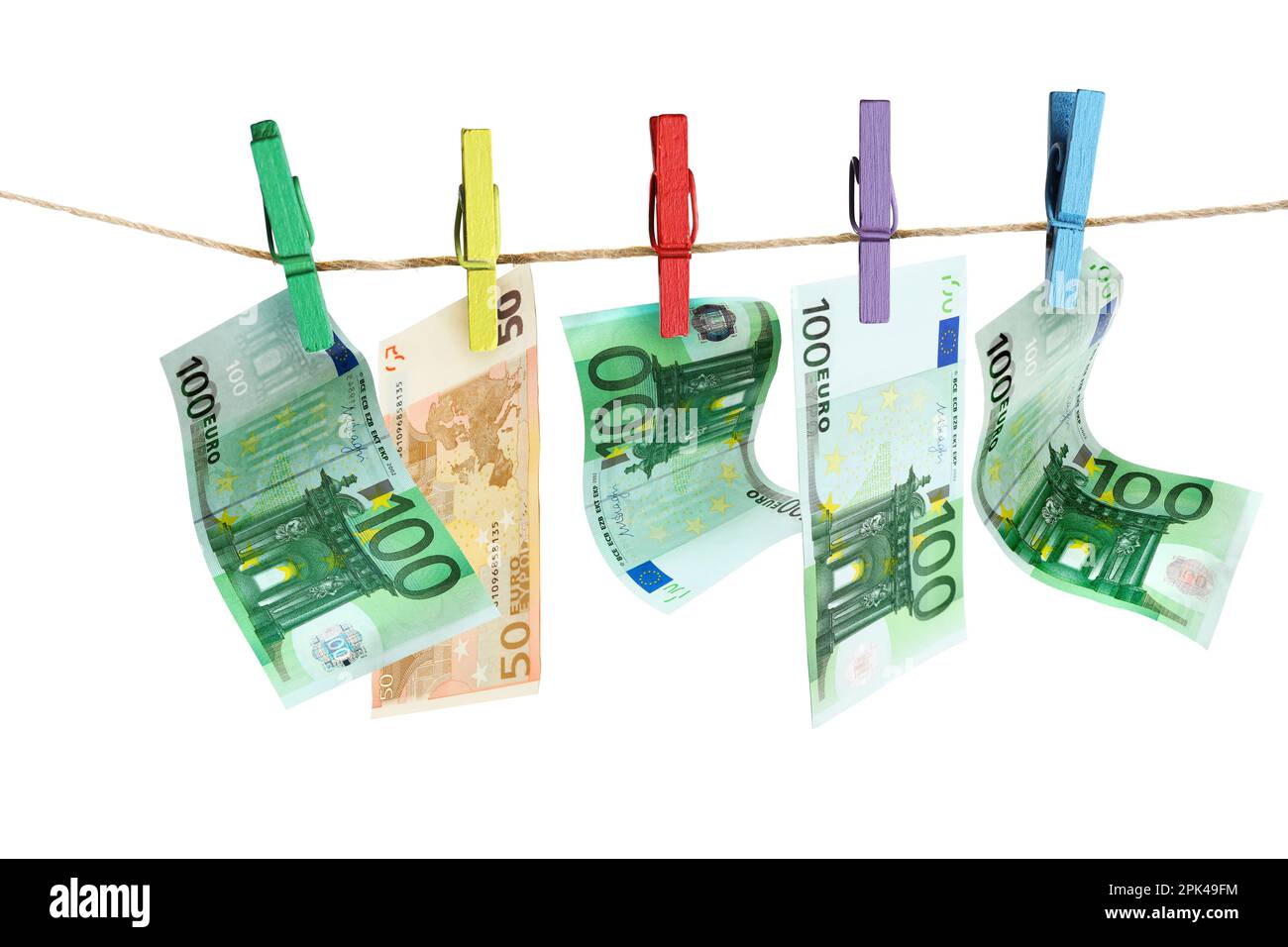Money laundering. Euro banknotes hanging on clothesline against white ...