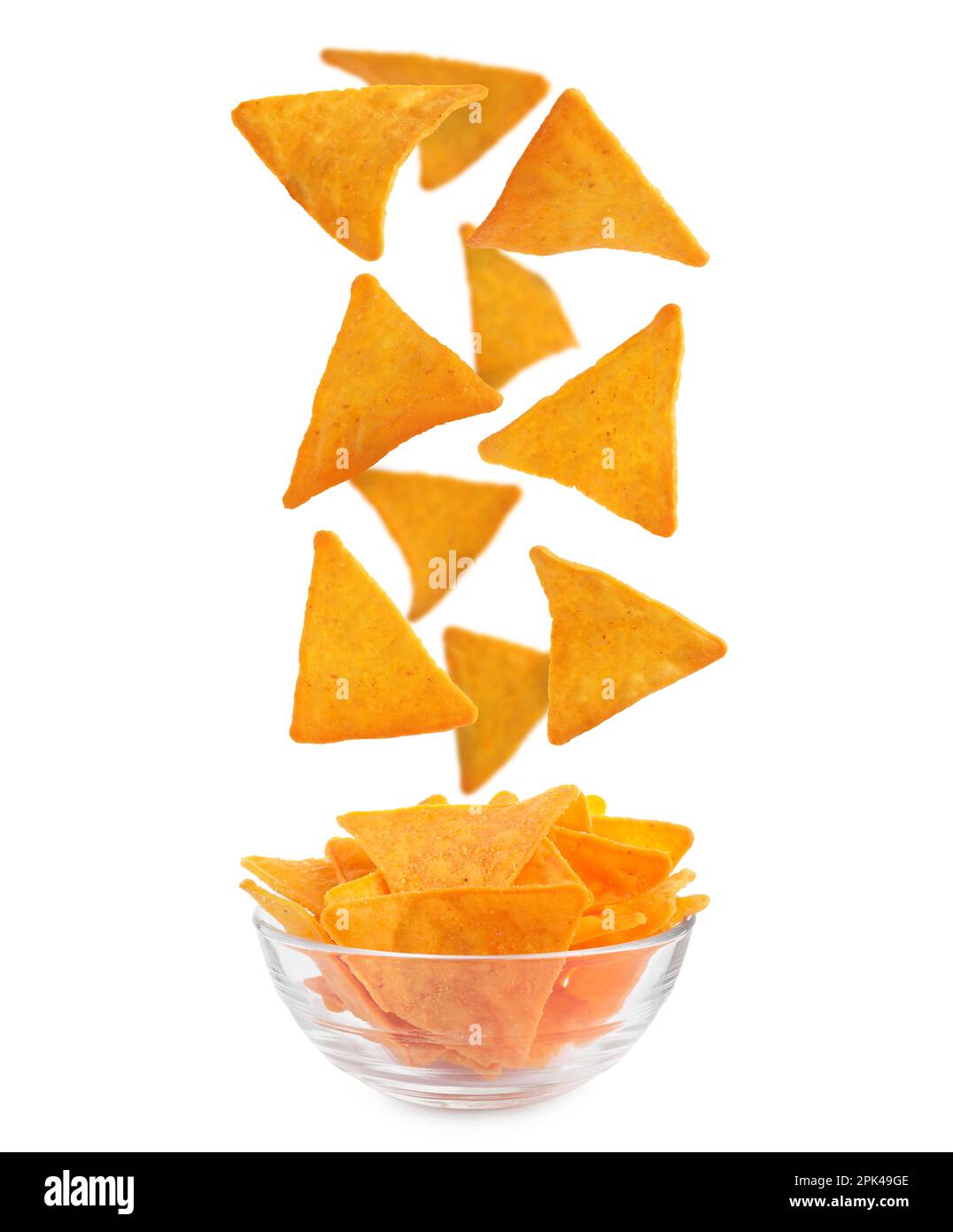 Tasty tortilla chips (nachos) falling into bowl on white background ...