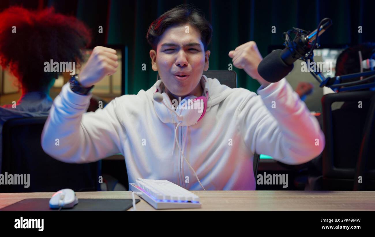 Game streamer using pc setup playing multiplayer first person shooter ...