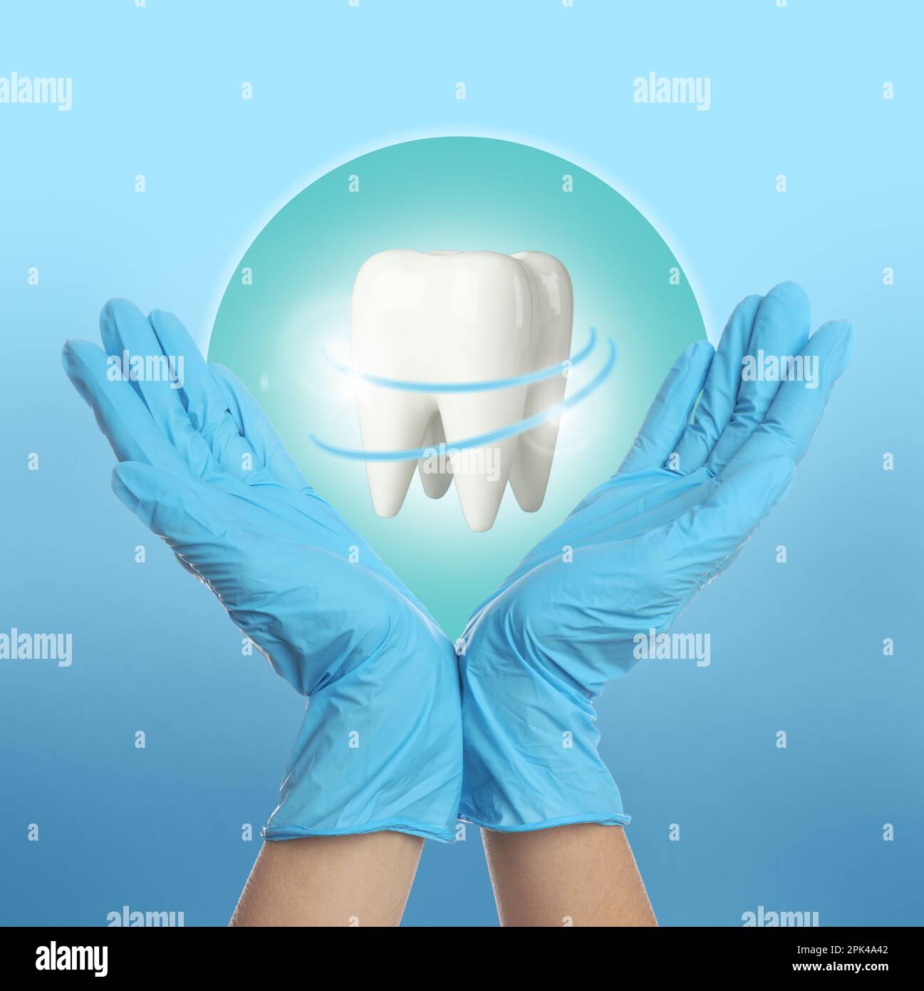 Dentist demonstrating virtual model of healthy tooth on light blue ...