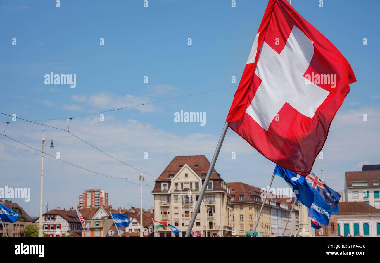 Beautiful Swiss flag is waving front of historical street in Basel ...