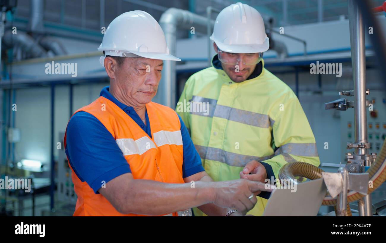Engineer specialist checking and controlling machine in industrial ...