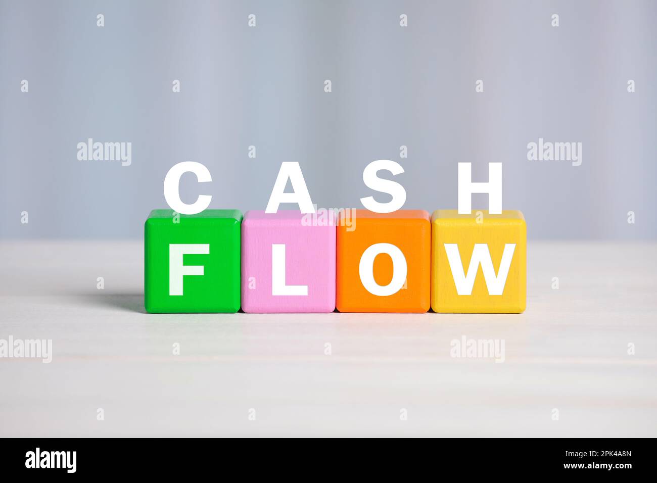 Phrase Cash Flow made with letters and colorful cubes on light ...