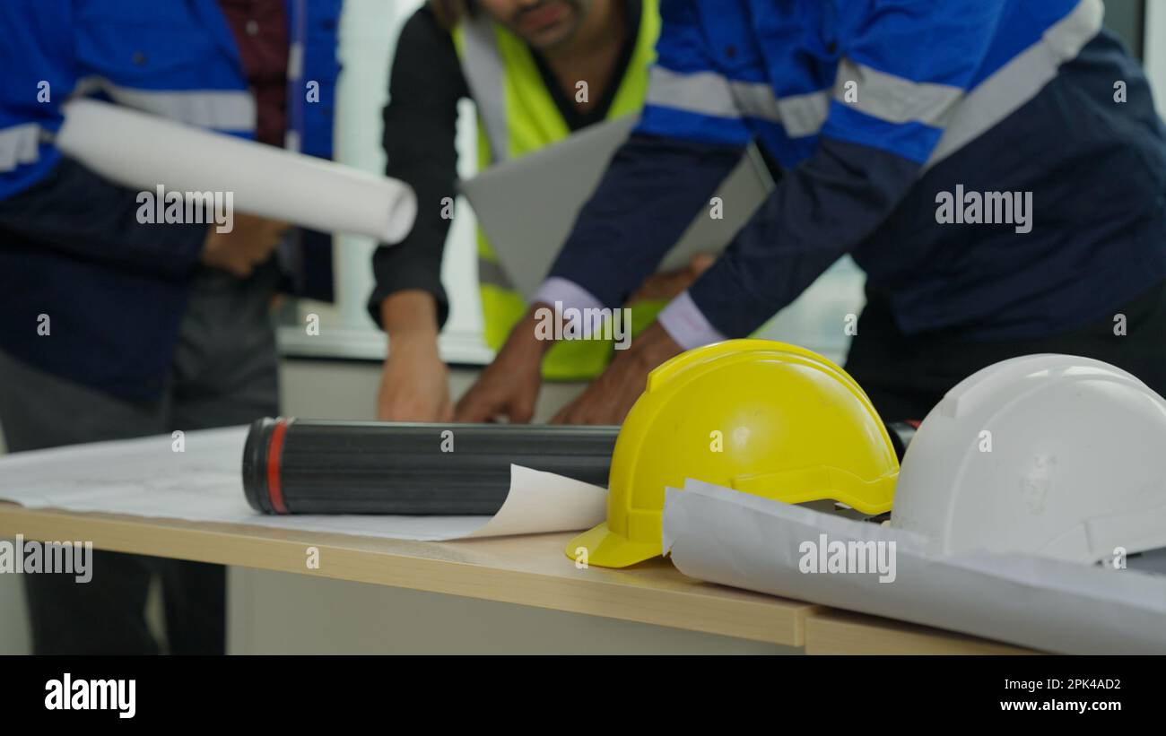 Construction engineers team using blueprint of project plan ...