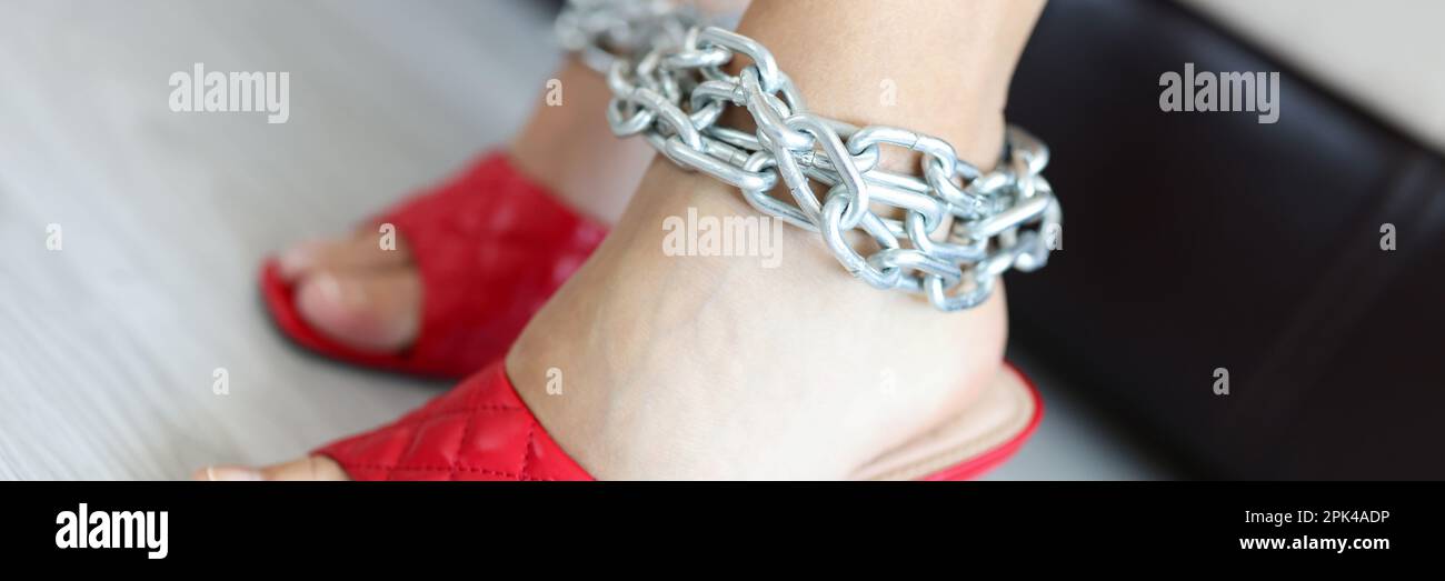 Chrome chain wrapped around woman legs in stylish sandals Stock Photo ...