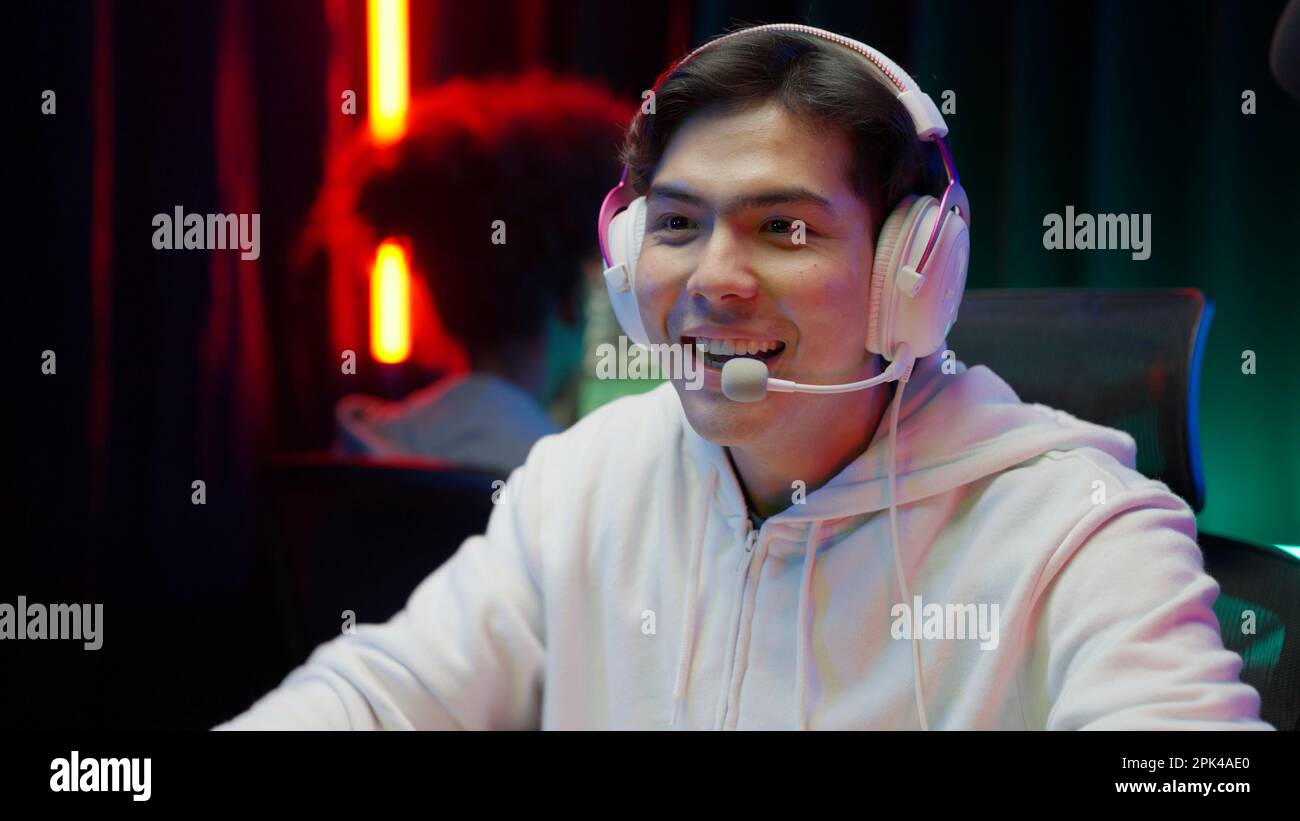 Game streamer using pc setup playing multiplayer first person shooter ...