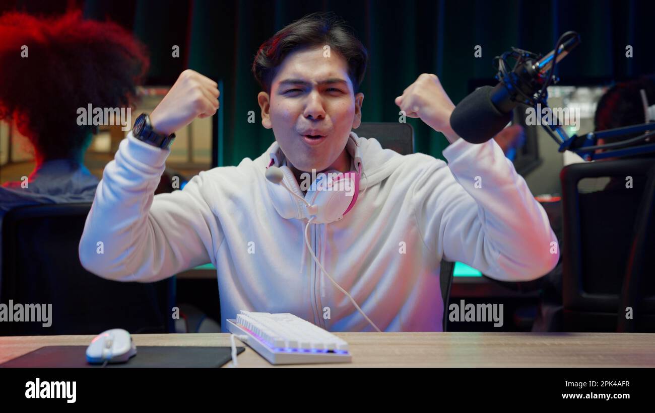 Game streamer using pc setup playing multiplayer first person shooter ...