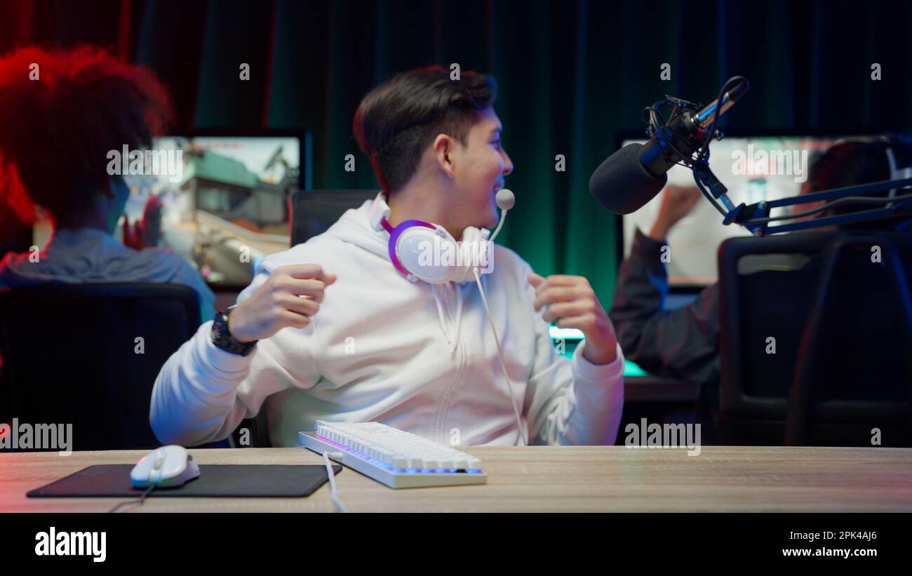 Game streamer using pc setup playing multiplayer first person shooter ...