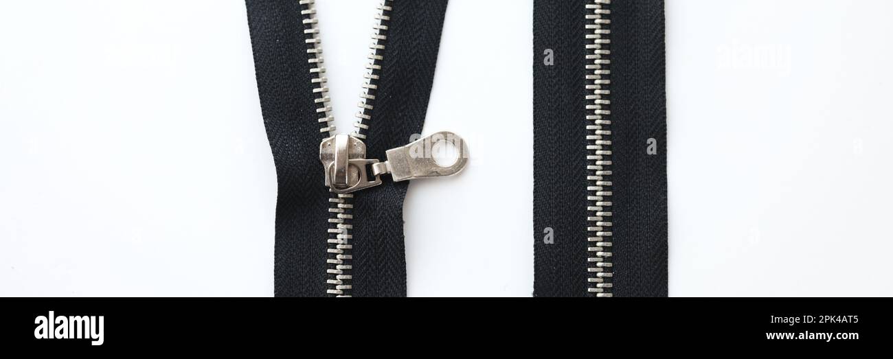 Open metal zippers for clothing on white background Stock Photo - Alamy