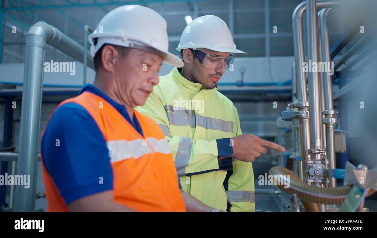 Engineer specialist checking and controlling machine in industrial ...