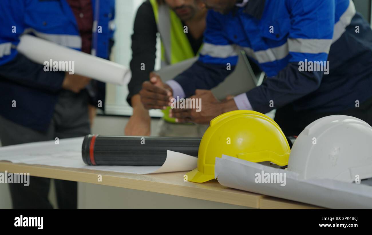 Construction engineers team using blueprint of project plan ...