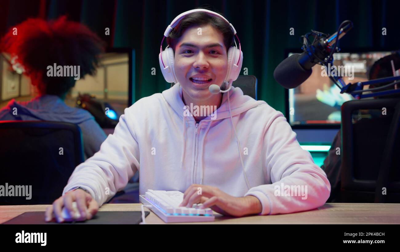 Game streamer using pc setup playing multiplayer first person shooter ...