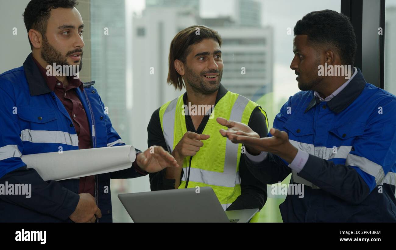 Construction engineers team using blueprint of project plan ...