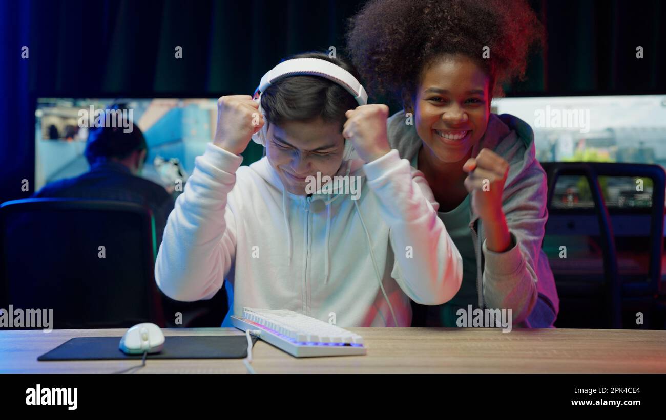 Game streamer using pc setup playing multiplayer first person shooter ...