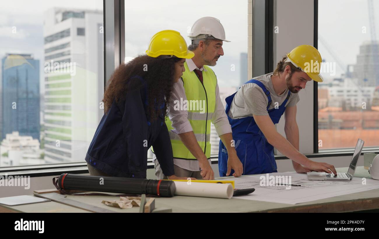 Professional construction engineers team using blueprint of project ...