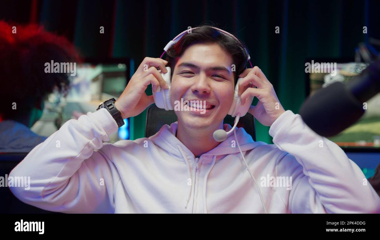 Game streamer using pc setup playing multiplayer first person shooter ...