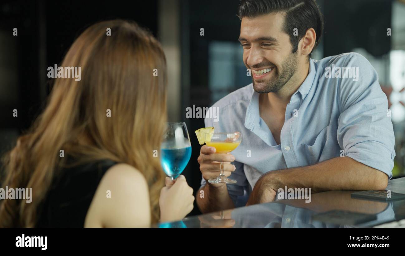 Couple of handsome man and beautiful woman drinking cocktails in luxury ...