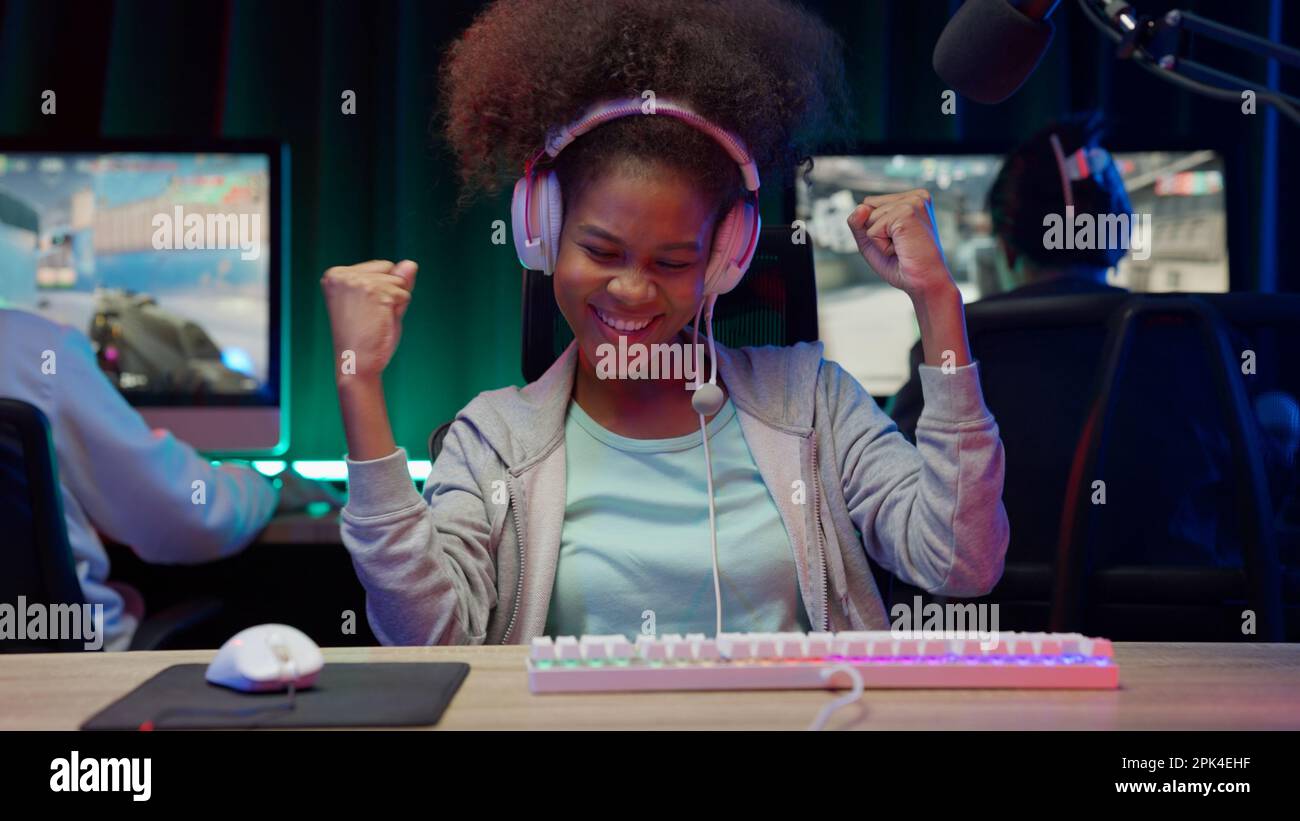 Game streamer using pc setup playing multiplayer first person shooter ...