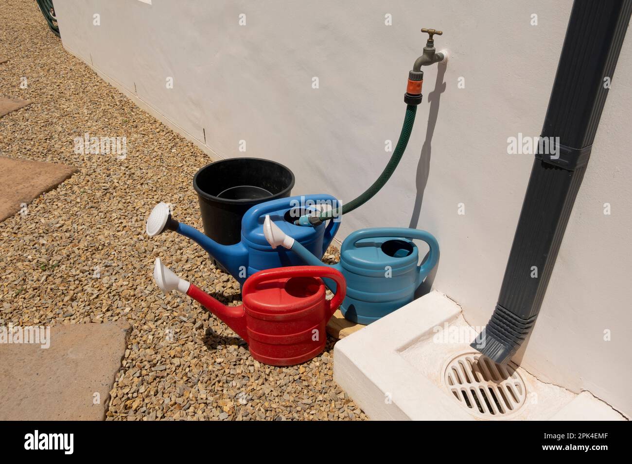 Langebaan, west coast, South Africa. 2023. Watering cans being filled ...