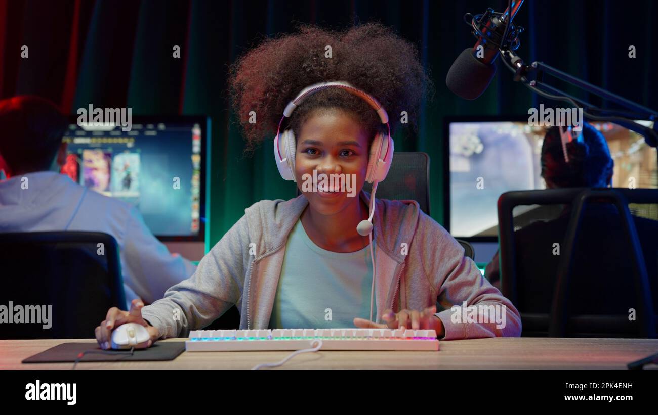 Game streamer using pc setup playing multiplayer first person shooter ...