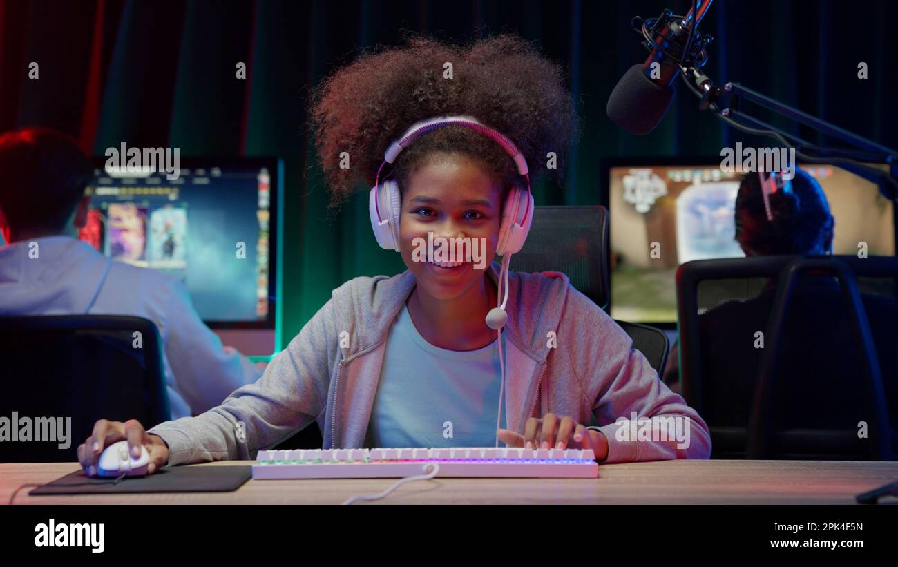 Game streamer using pc setup playing multiplayer first person shooter ...