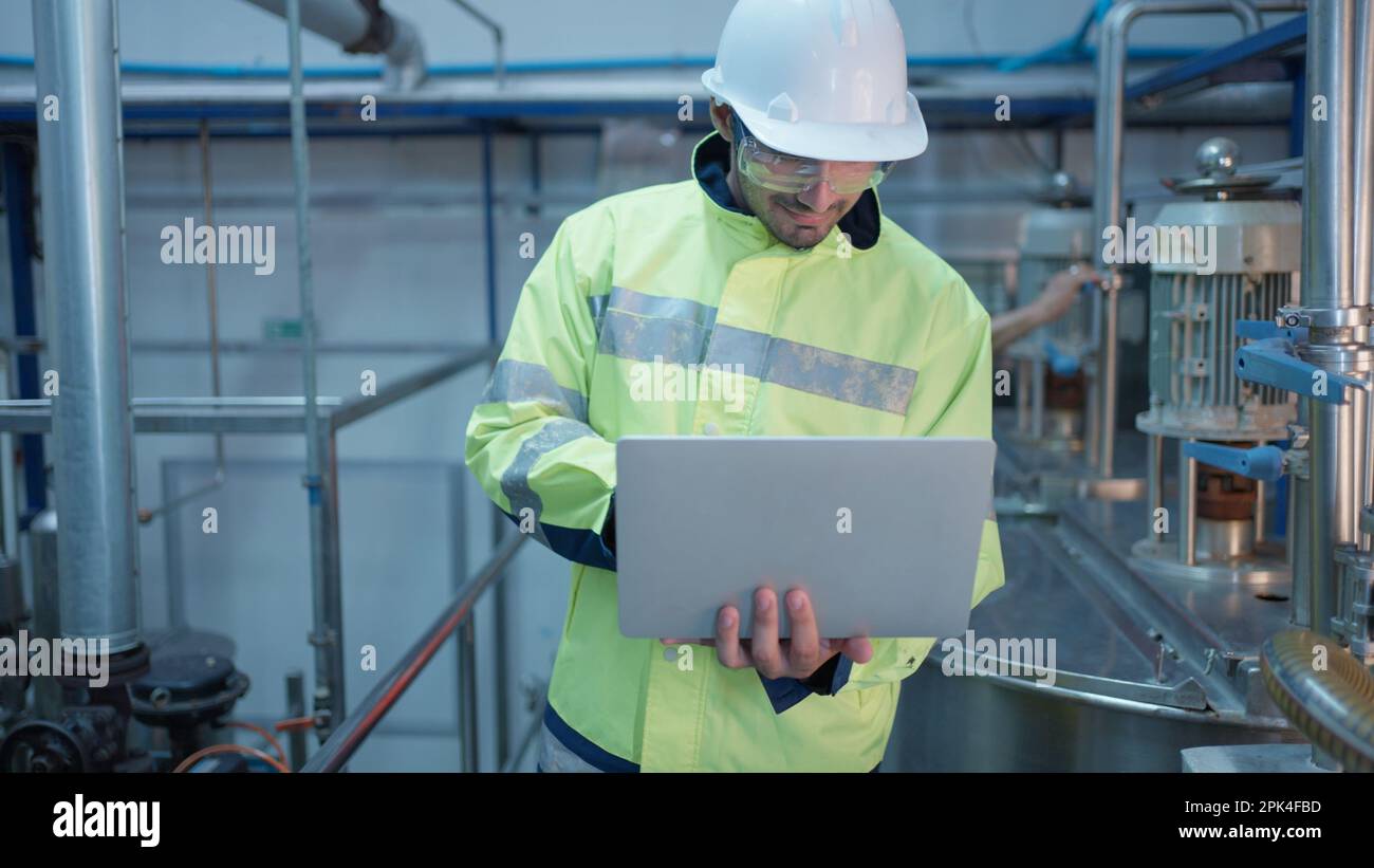 Engineer specialist checking and controlling machine in industrial ...