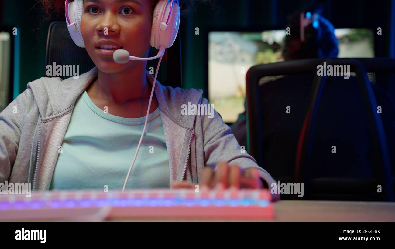 Game streamer using pc setup playing multiplayer first person shooter ...