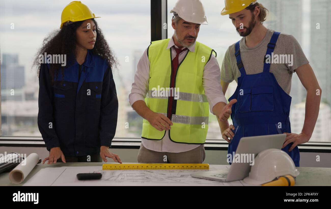 Professional construction engineers team using blueprint of project ...