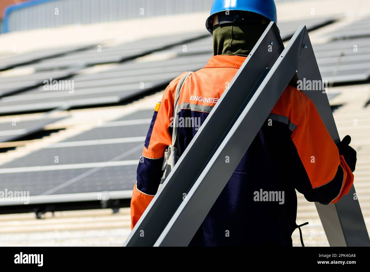 Maintenance worker with safety helmet working at solar power station ...