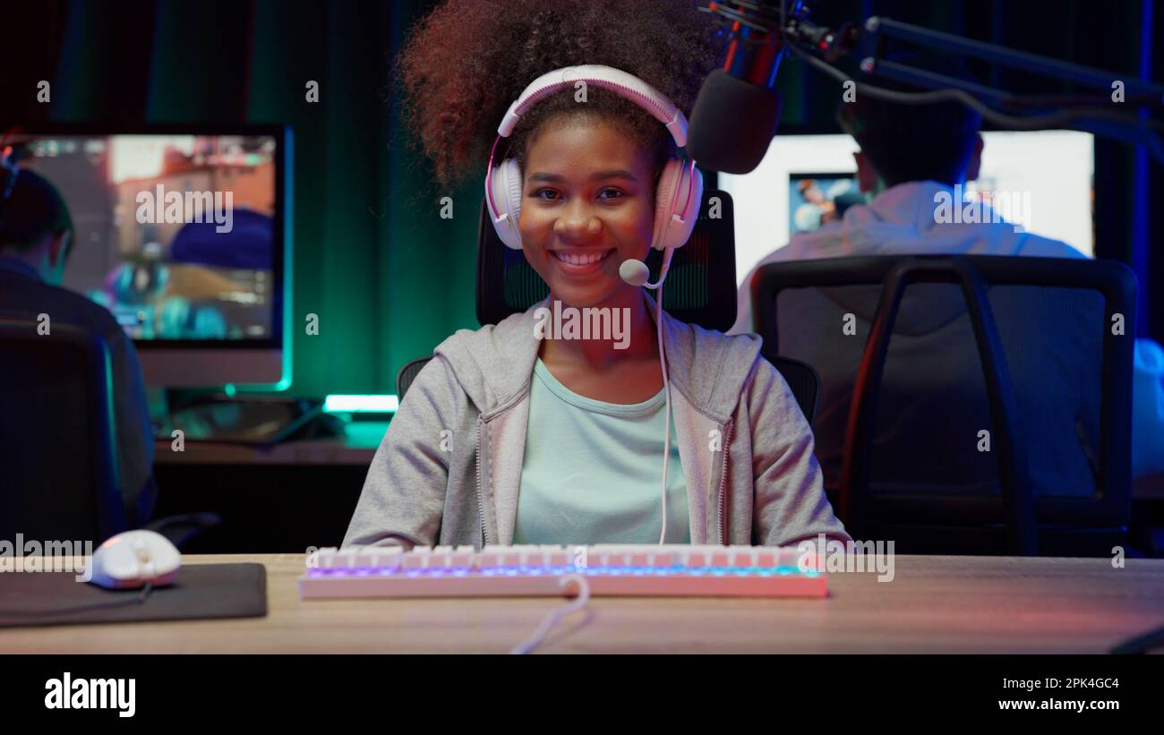 Game streamer using pc setup playing multiplayer first person shooter ...