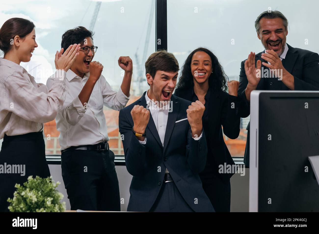 Happy business employees team celebrating success with praise in ...