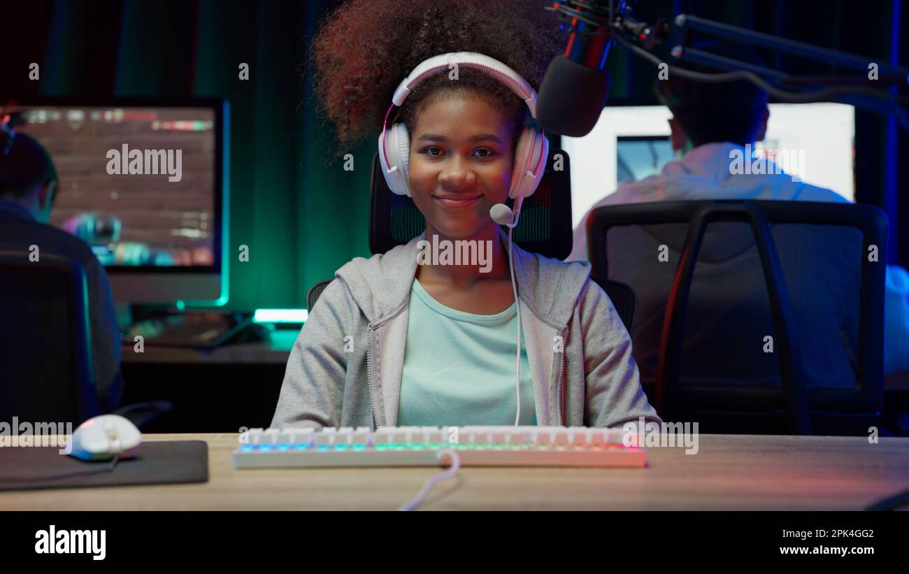 Game streamer using pc setup playing multiplayer first person shooter ...