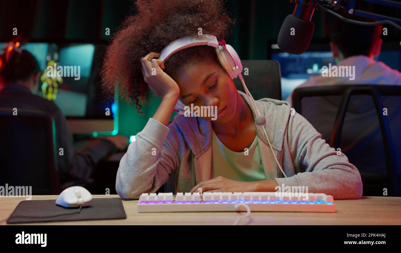 Game streamer using pc setup playing multiplayer first person shooter ...