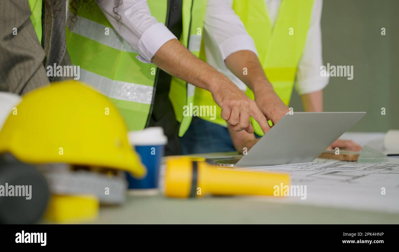 Professional construction engineers team using blueprint of project ...