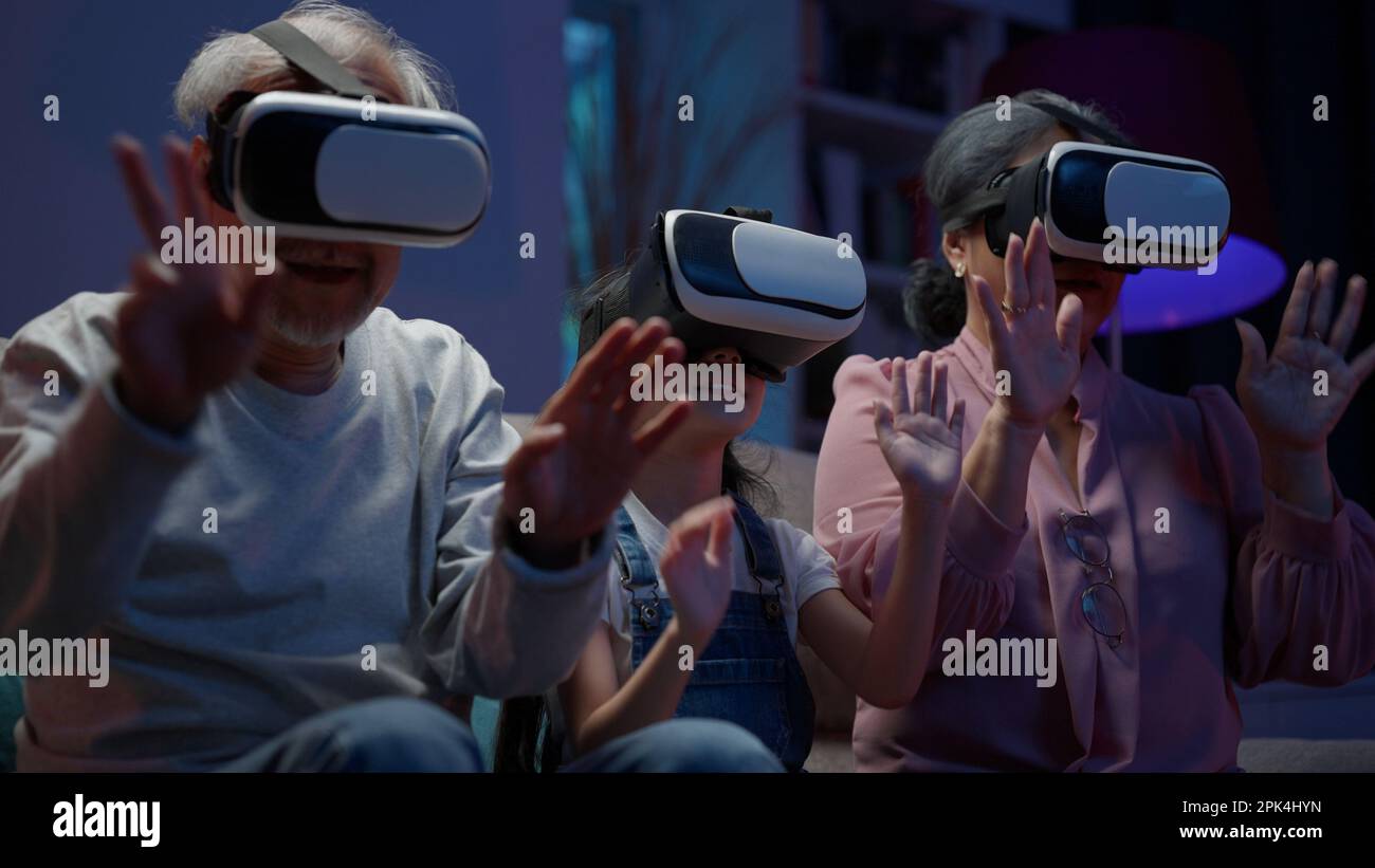 Cheerful girl playing metaverse gaming with wearable VR headset Stock ...