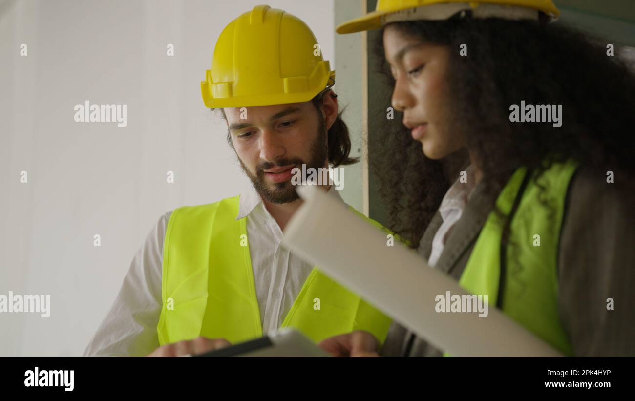 Engineers using tablet talking and brainstorming together on ...